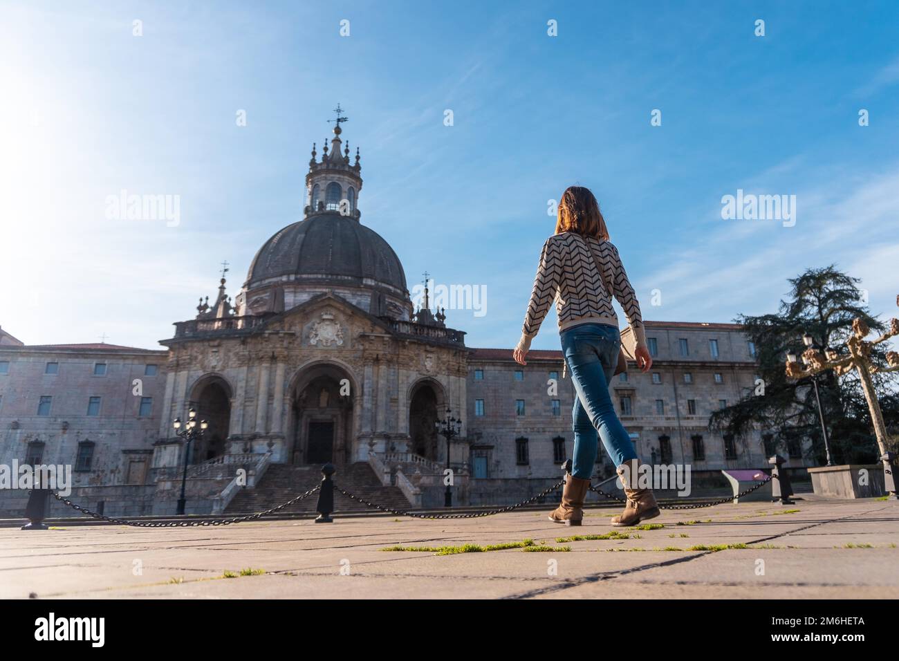 A young woman visiting the Sanctuary of Loyola, Baroque church of ...