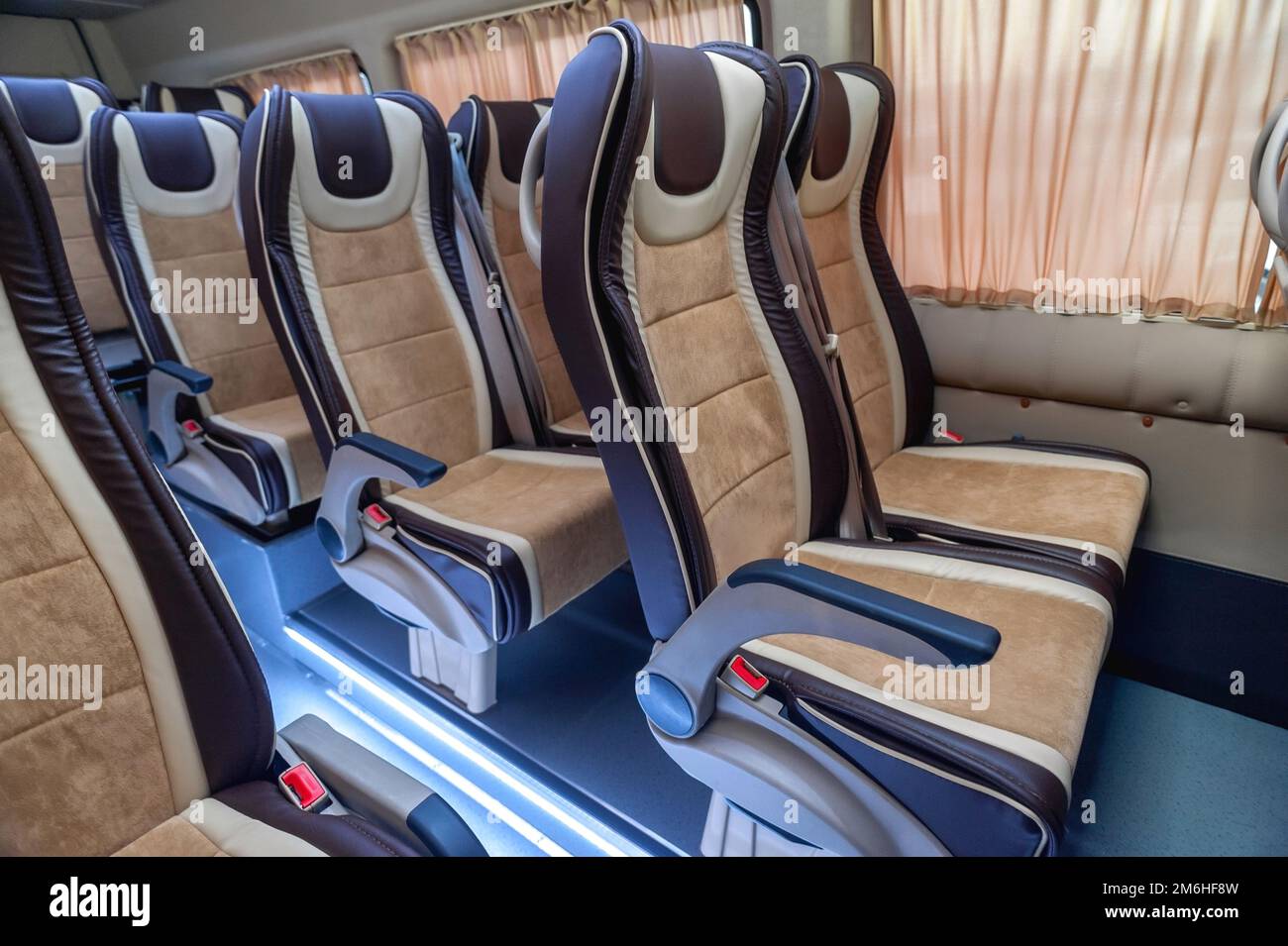 comfortable passenger bus interior with upholstered seats; individual ...
