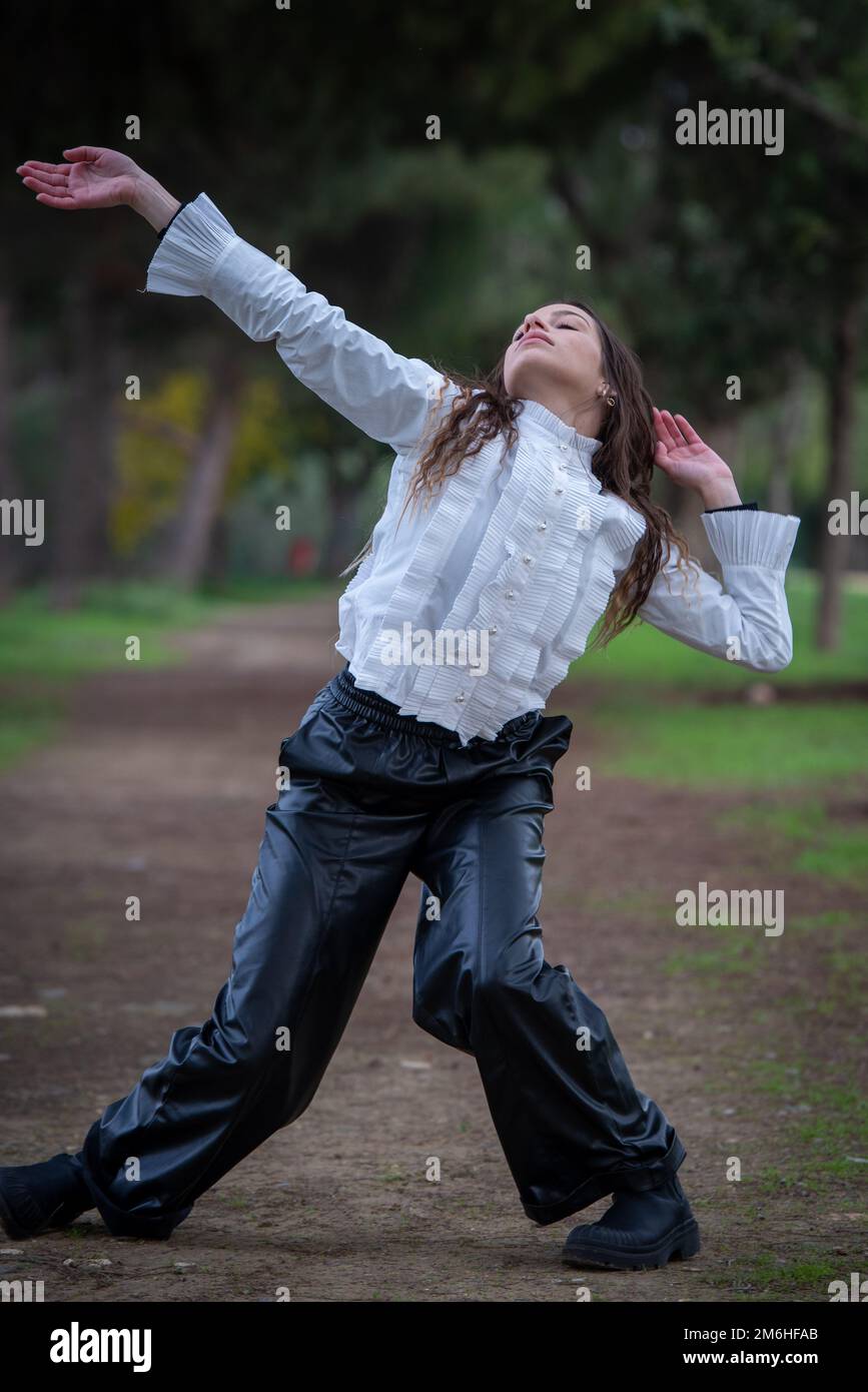 Young woman dancing outdoors. Dance performance in the street Stock ...