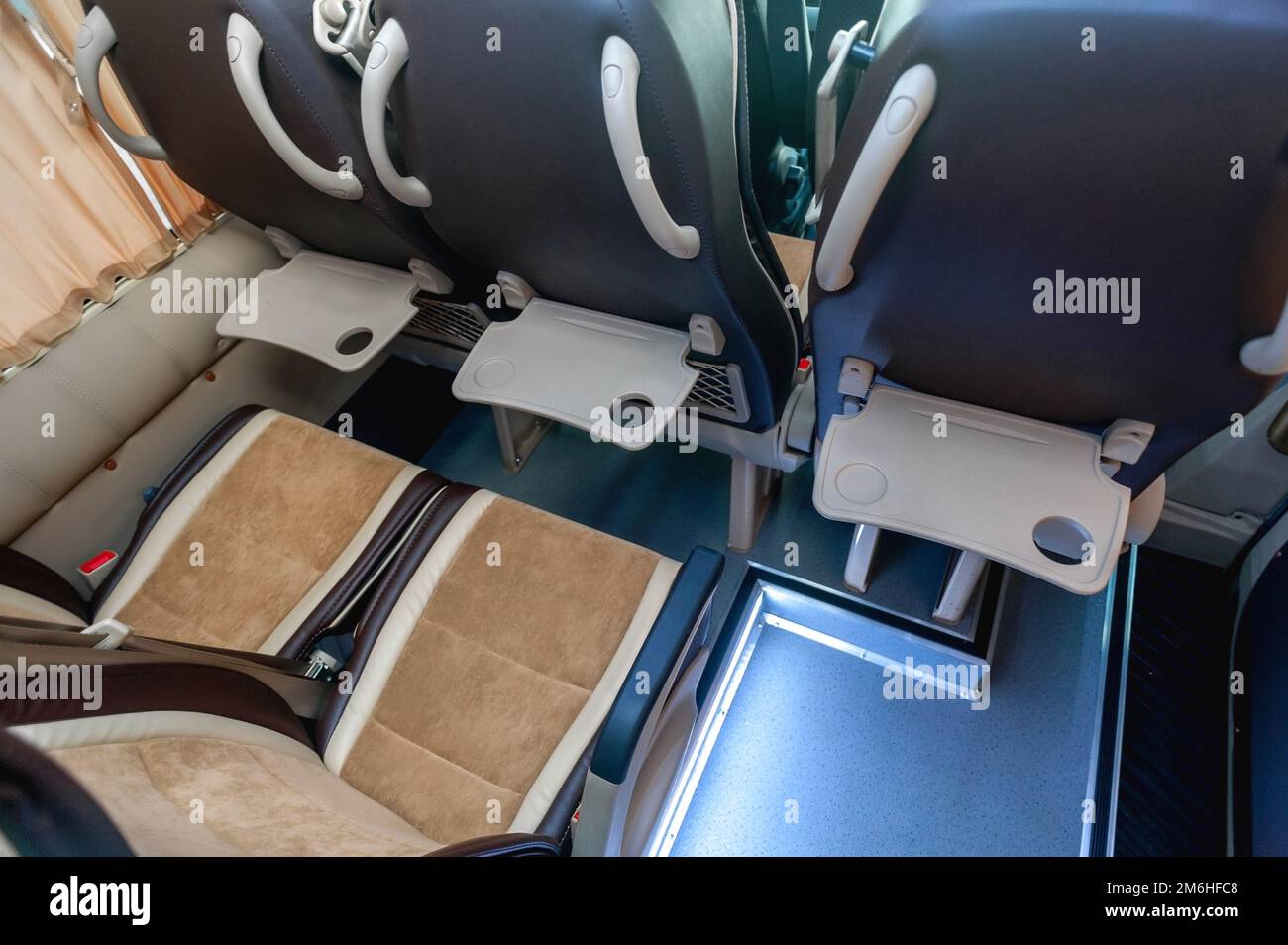 comfortable passenger bus interior with upholstered seats; individual ...