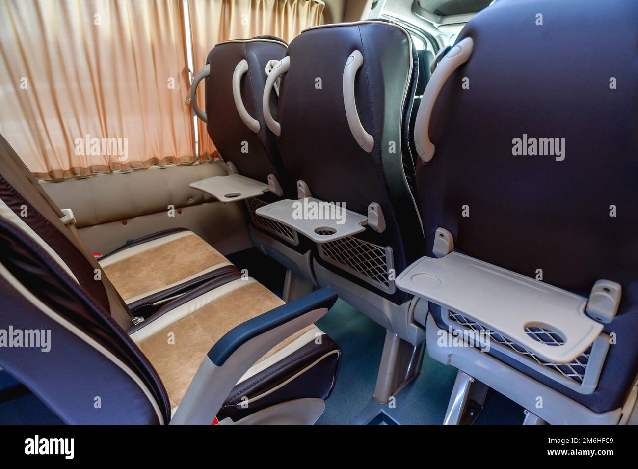 comfortable passenger bus interior with upholstered seats; individual ...