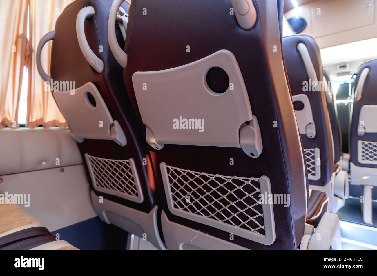 comfortable passenger bus interior with upholstered seats; individual ...