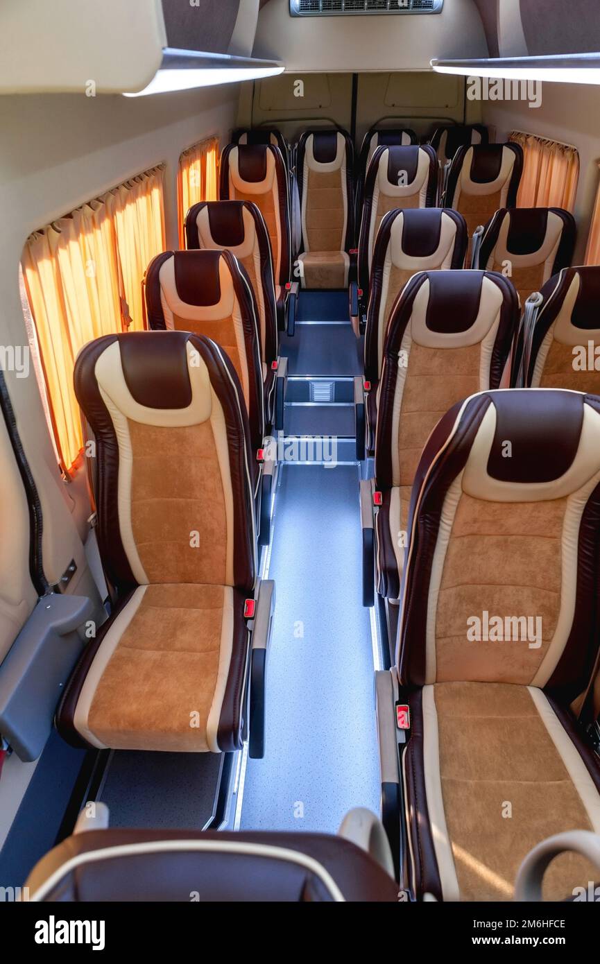 comfortable passenger bus interior with upholstered seats; individual ...