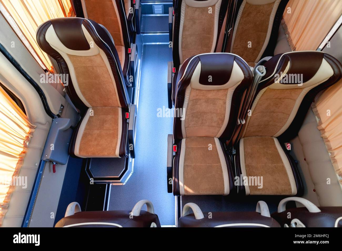 comfortable passenger bus interior with upholstered seats; individual ...