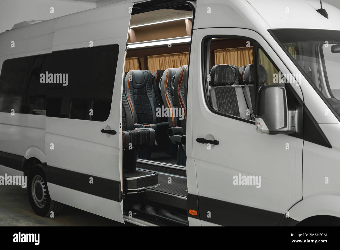 comfortable passenger bus interior with upholstered seats; individual ...