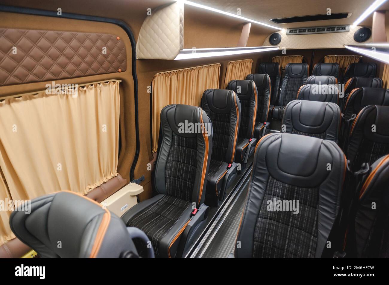 comfortable passenger bus interior with upholstered seats; individual ...