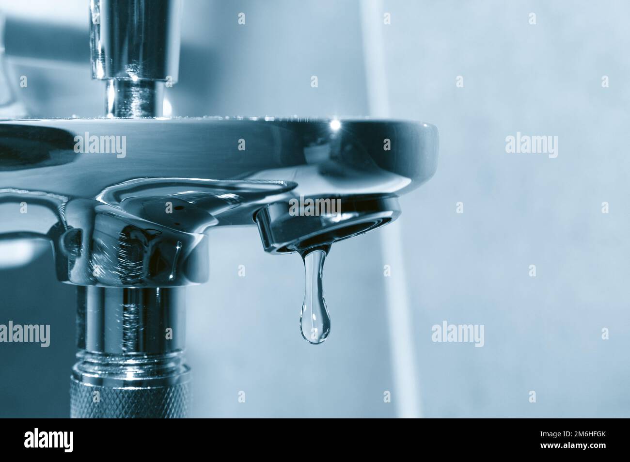Chrome tap with falling water drop close up Stock Photo - Alamy