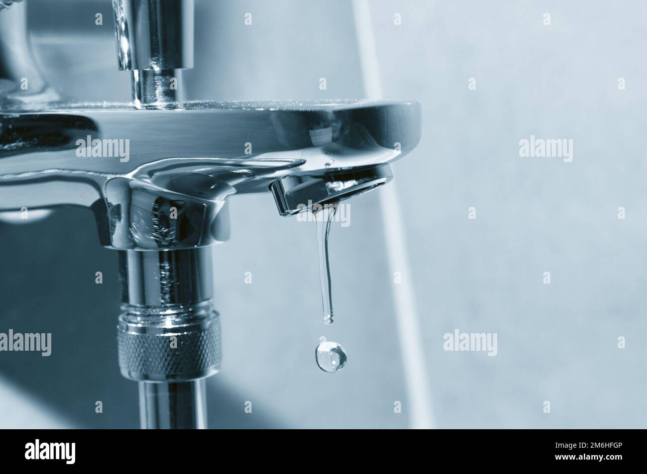 Chrome tap with falling water drop close up Stock Photo - Alamy