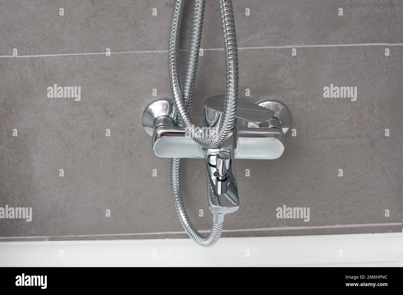 Chrome shower faucet close up in a bathroom Stock Photo - Alamy