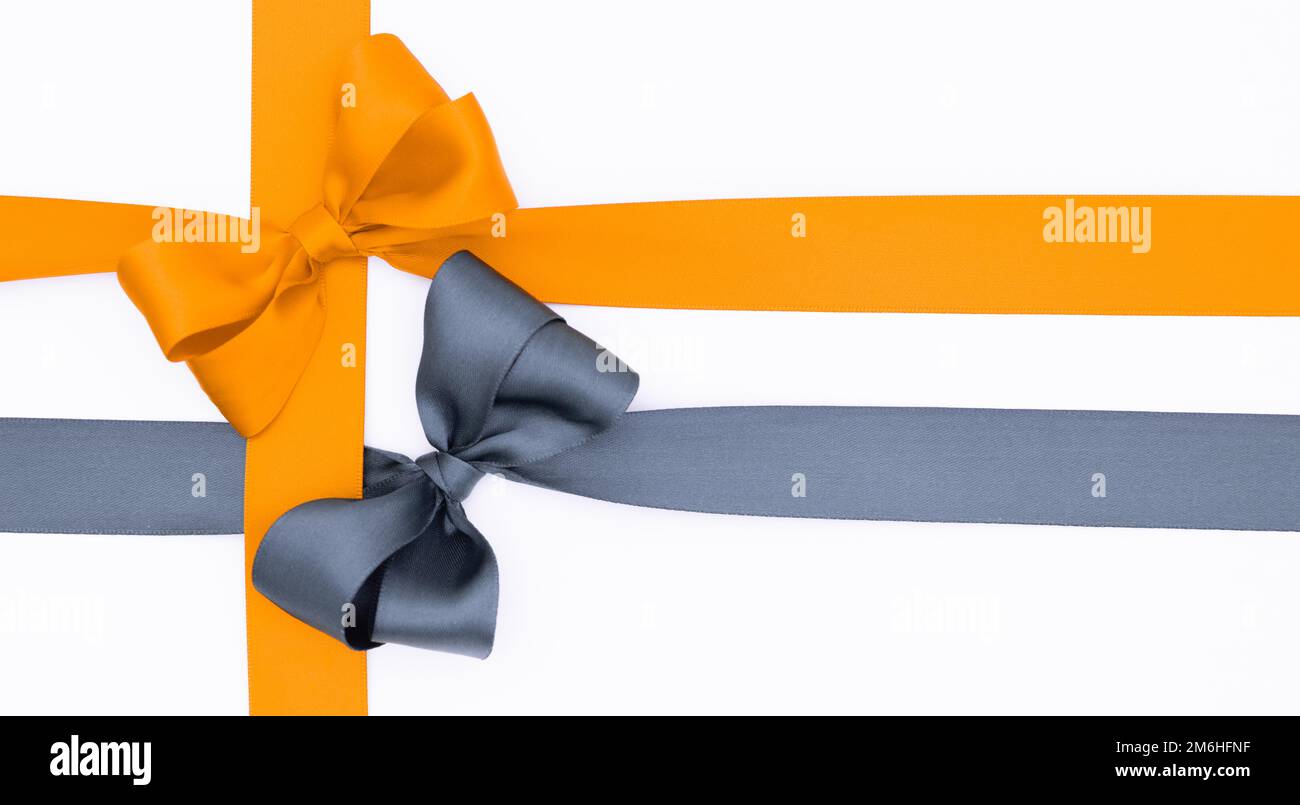 Satin ribbon bows for gift pack in gray and yellow colors, isolated on ...