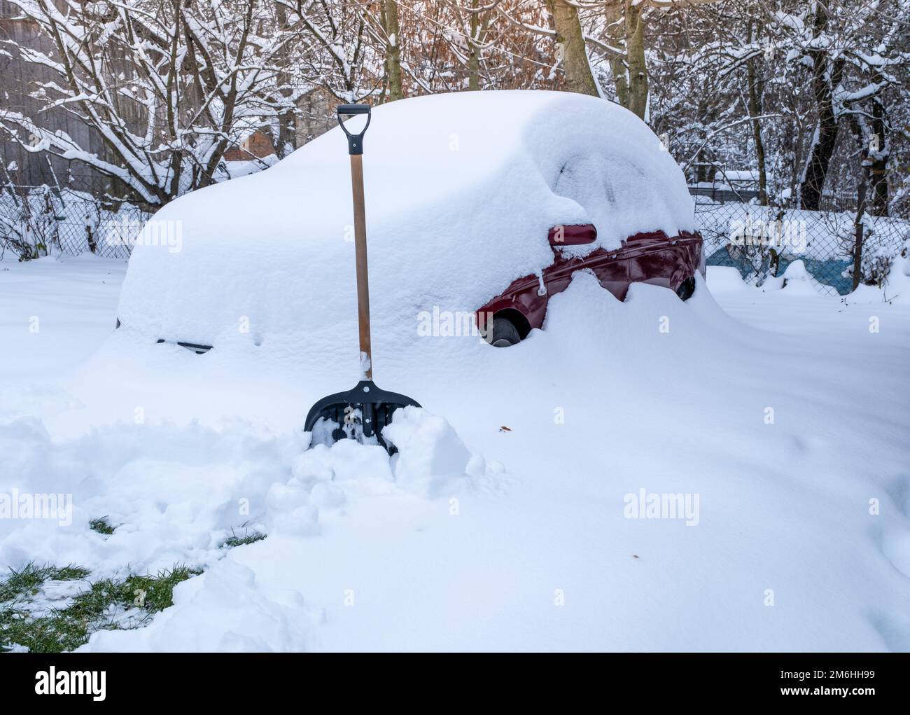 Clearing the car from a large amount of snow Stock Photo - Alamy
