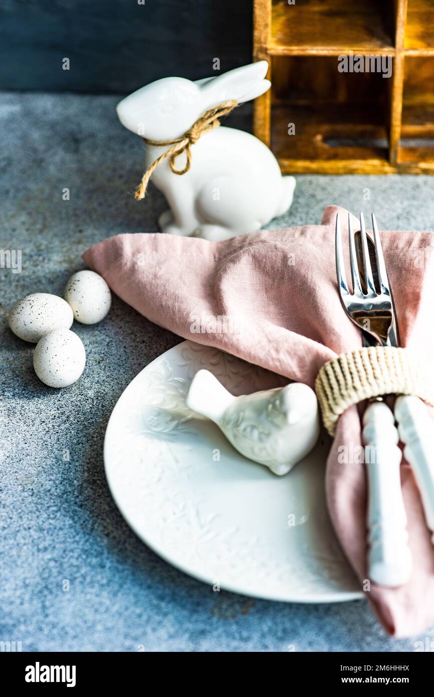Easter table setting on concrete background Stock Photo - Alamy