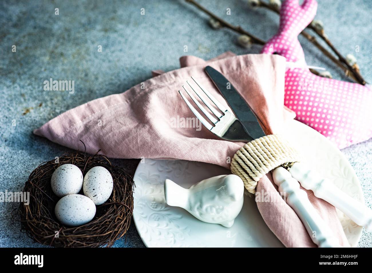 Easter table setting on concrete background Stock Photo - Alamy