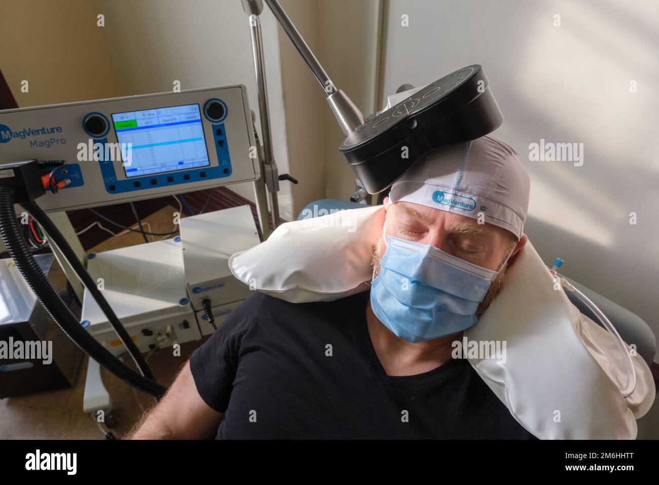 Montreal, CA - 15 november 2022: Patient undergoing Repetitive Transcranial Magnetic Stimulation ...