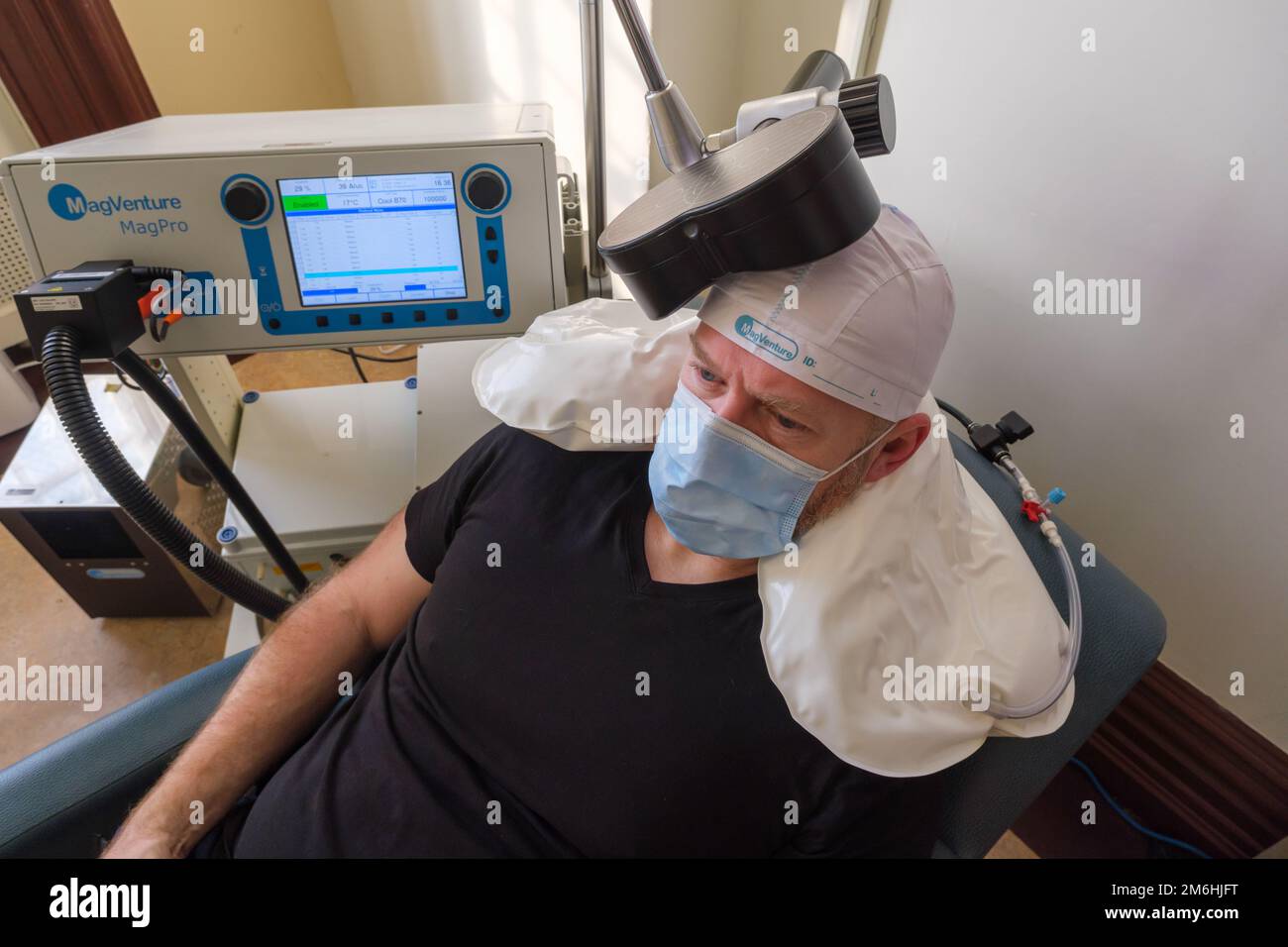 Montreal, CA - 15 november 2022: Patient undergoing Repetitive Transcranial Magnetic Stimulation ...