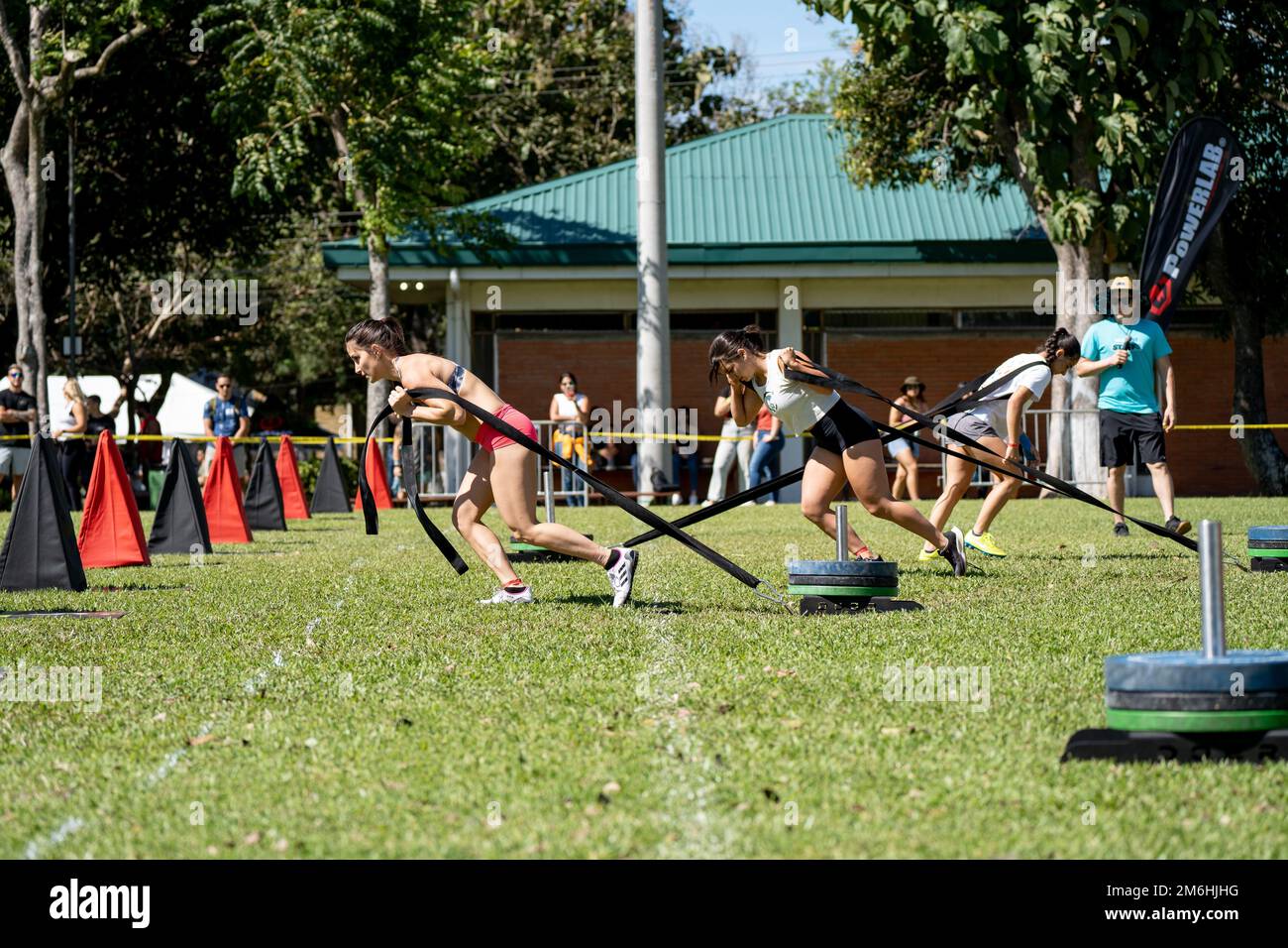 The strong athletes pulling weights with body at outdoor fitness and ...