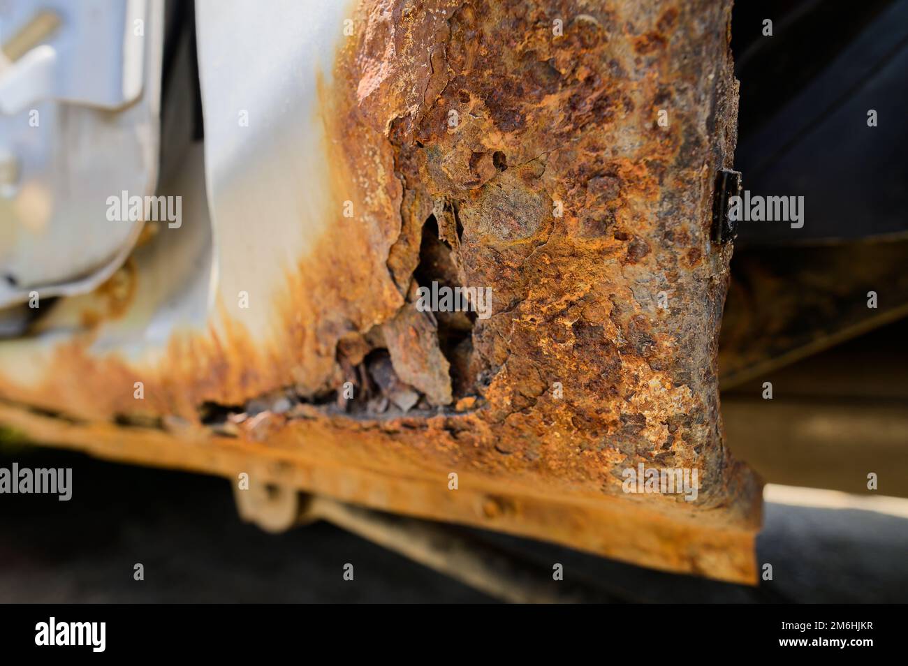 Fragment of a car body with rust. fragment of a rusty wing of a car ...