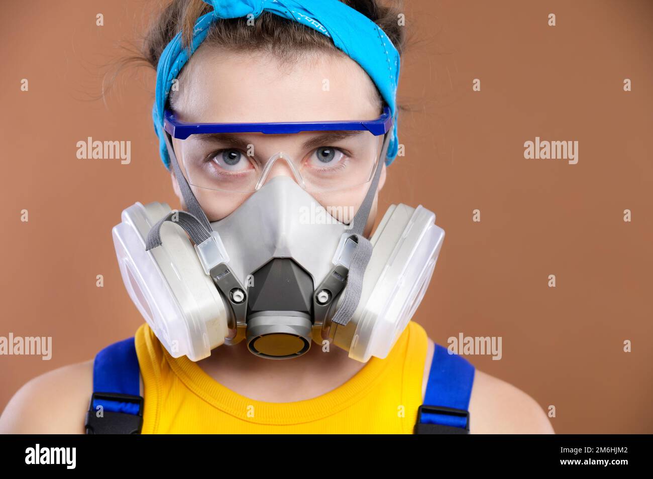 Portrait of a young Caucasian woman in protective equipment for the ...