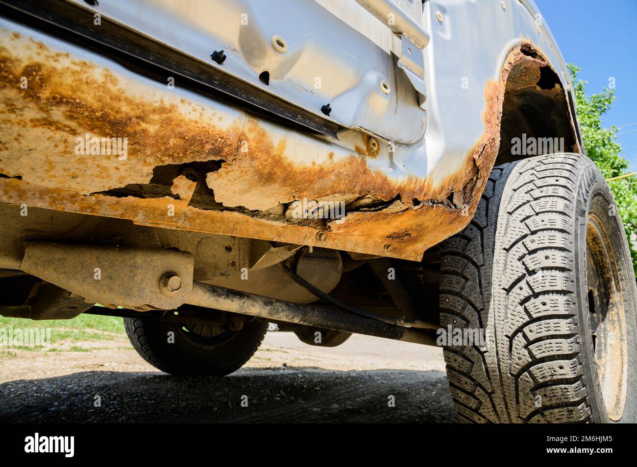 Fragment of a car body with rust. fragment of a rusty wing of a car ...