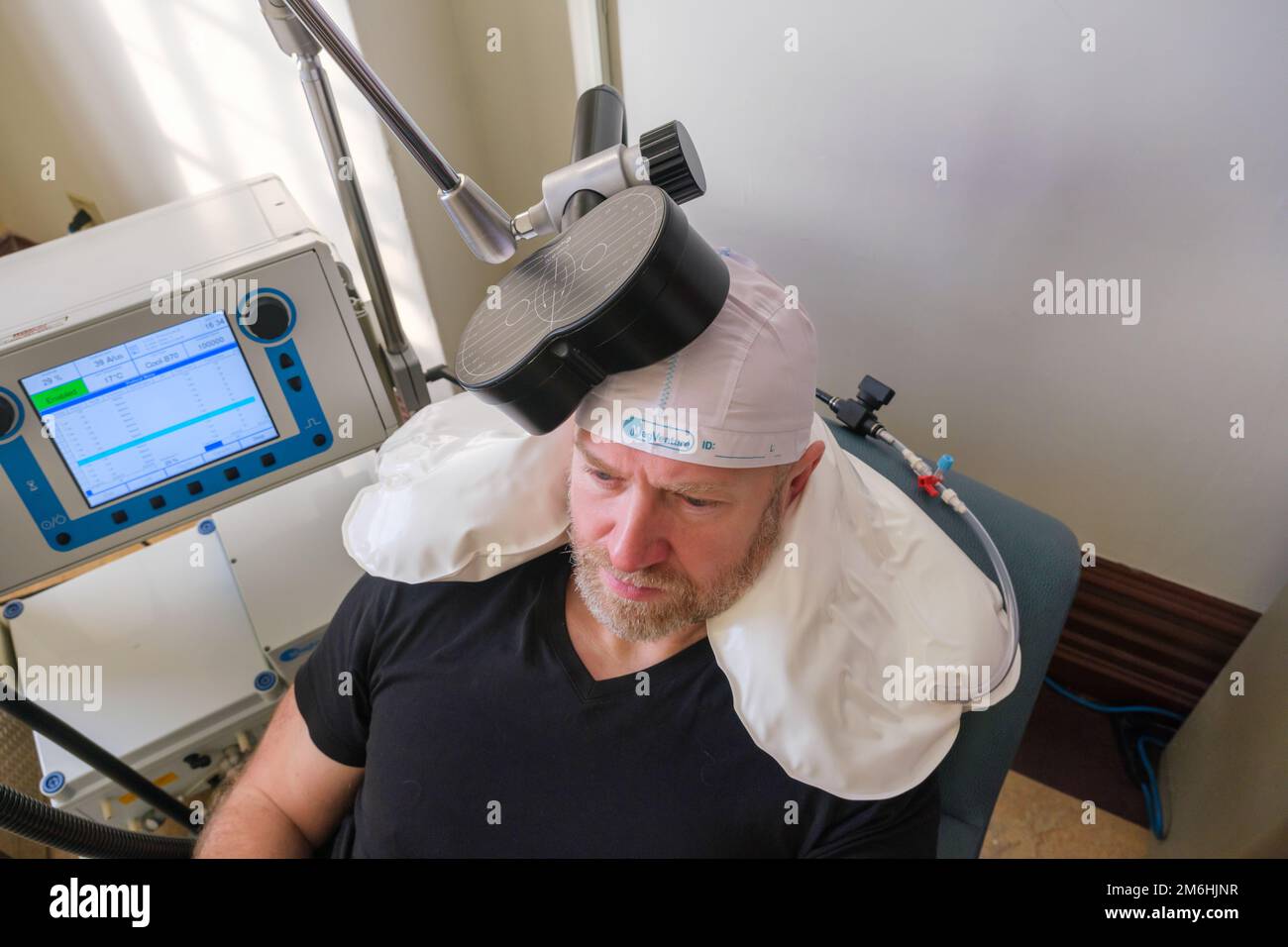Montreal, CA - 15 november 2022: Patient undergoing Repetitive Transcranial Magnetic Stimulation ...
