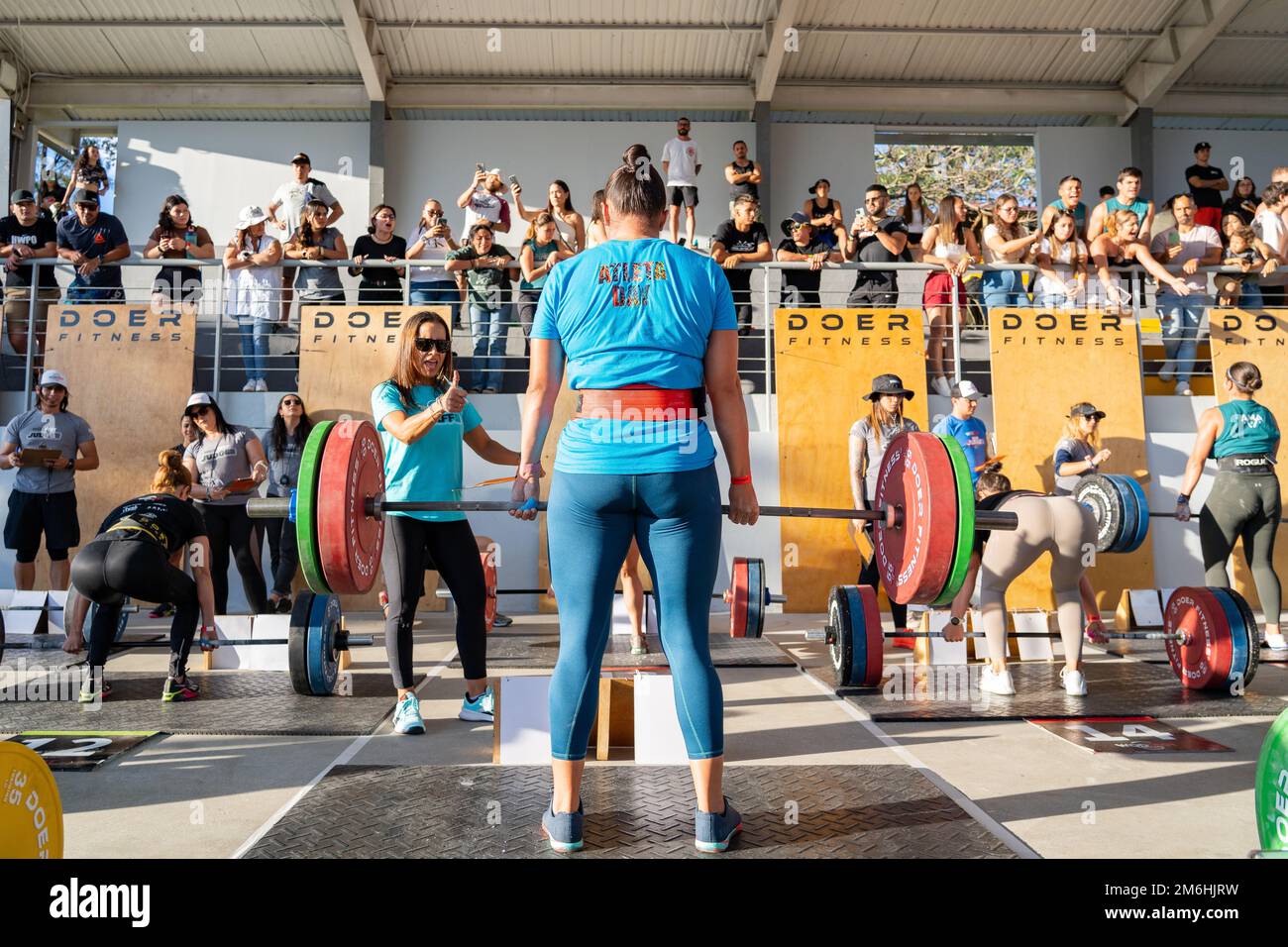A group of people at an indoor fitness and endurance competition in ...