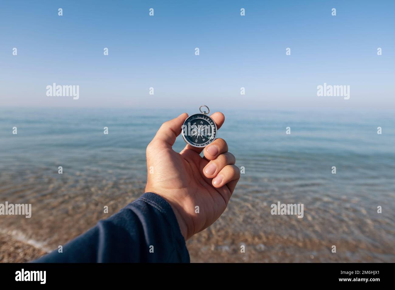 The traveler is looking for direction with a compass on the coastline ...
