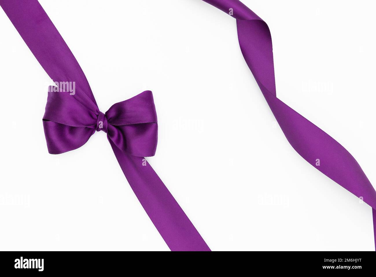Satin ribbon bow for gift pack in purple color, isolated on white ...