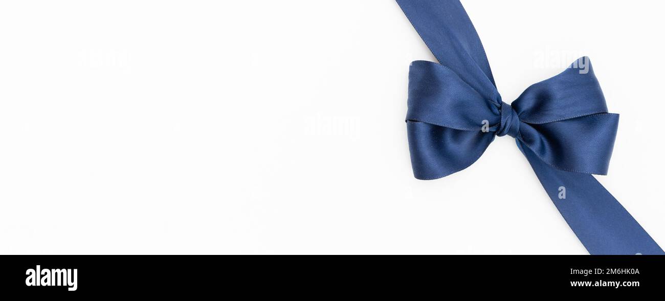 Satin ribbon bow for gift pack in blue color, isolated on white ...