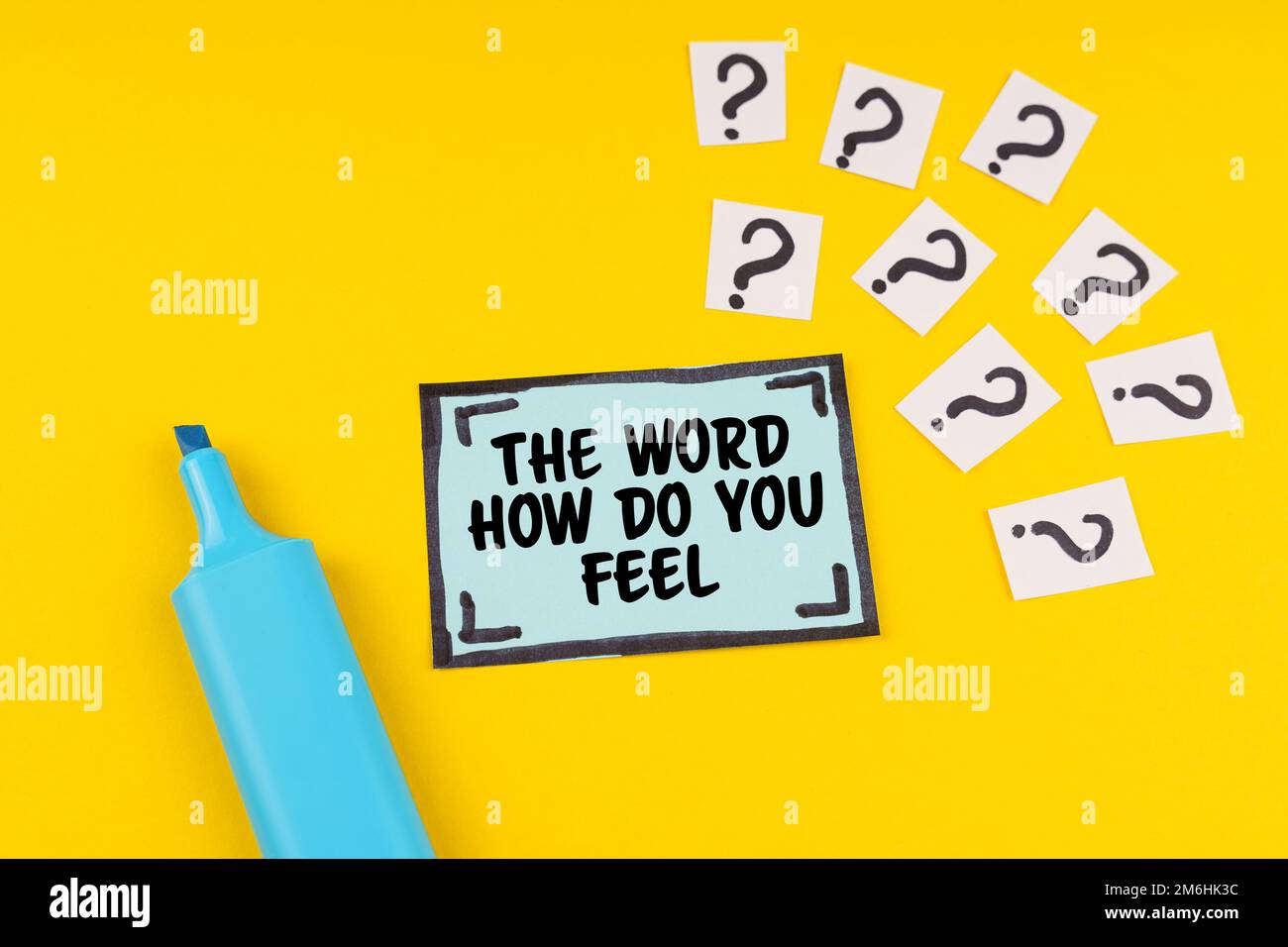 Business concept. On the yellow surface lies a blue marker, question ...