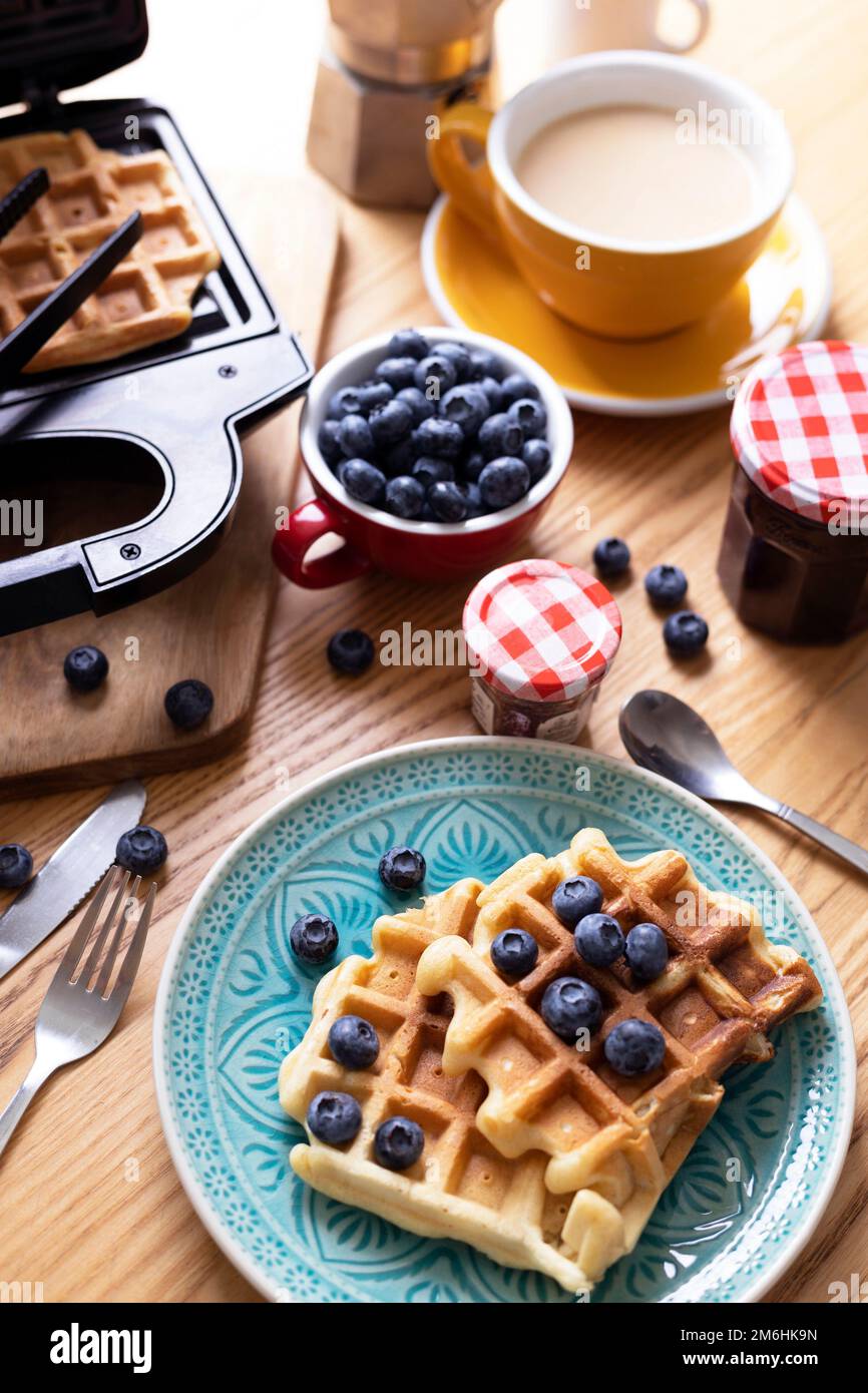 morning and bright breakfast. belgian waffles with blueberries and ...