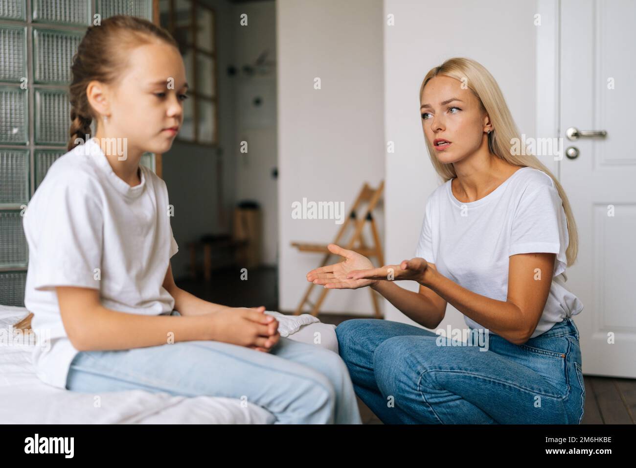 Irritated young mother lecturing little stubborn daughter for bad ...