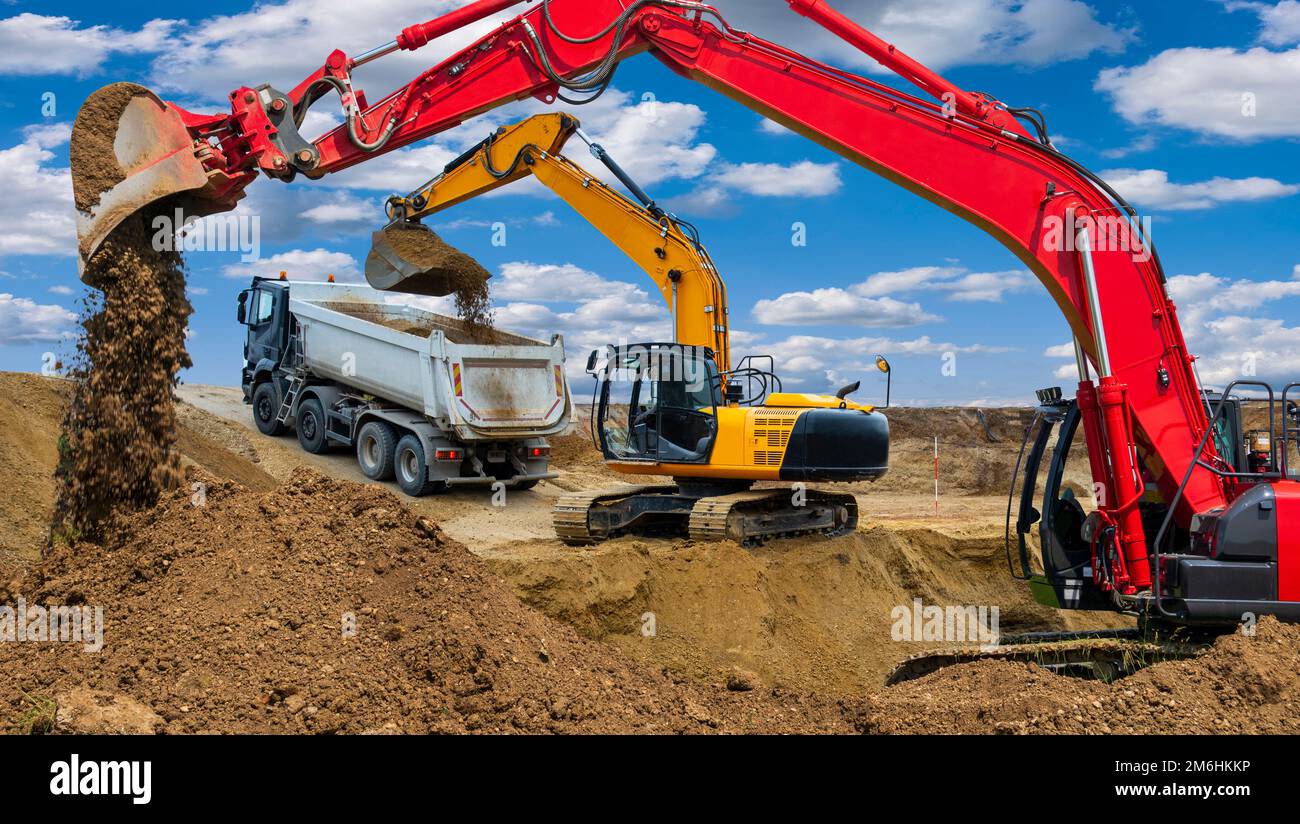 Excavator on construction site and truck at work Stock Photo - Alamy