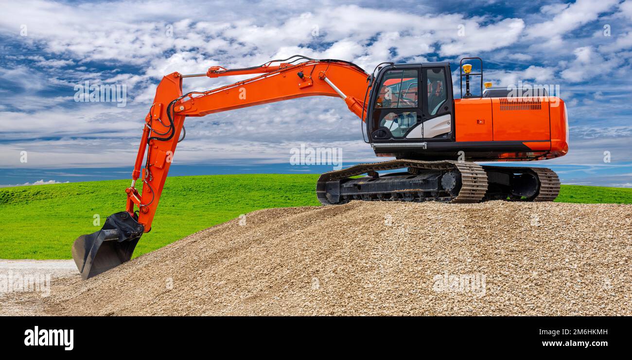 Excavator on construction site and truck at work Stock Photo - Alamy