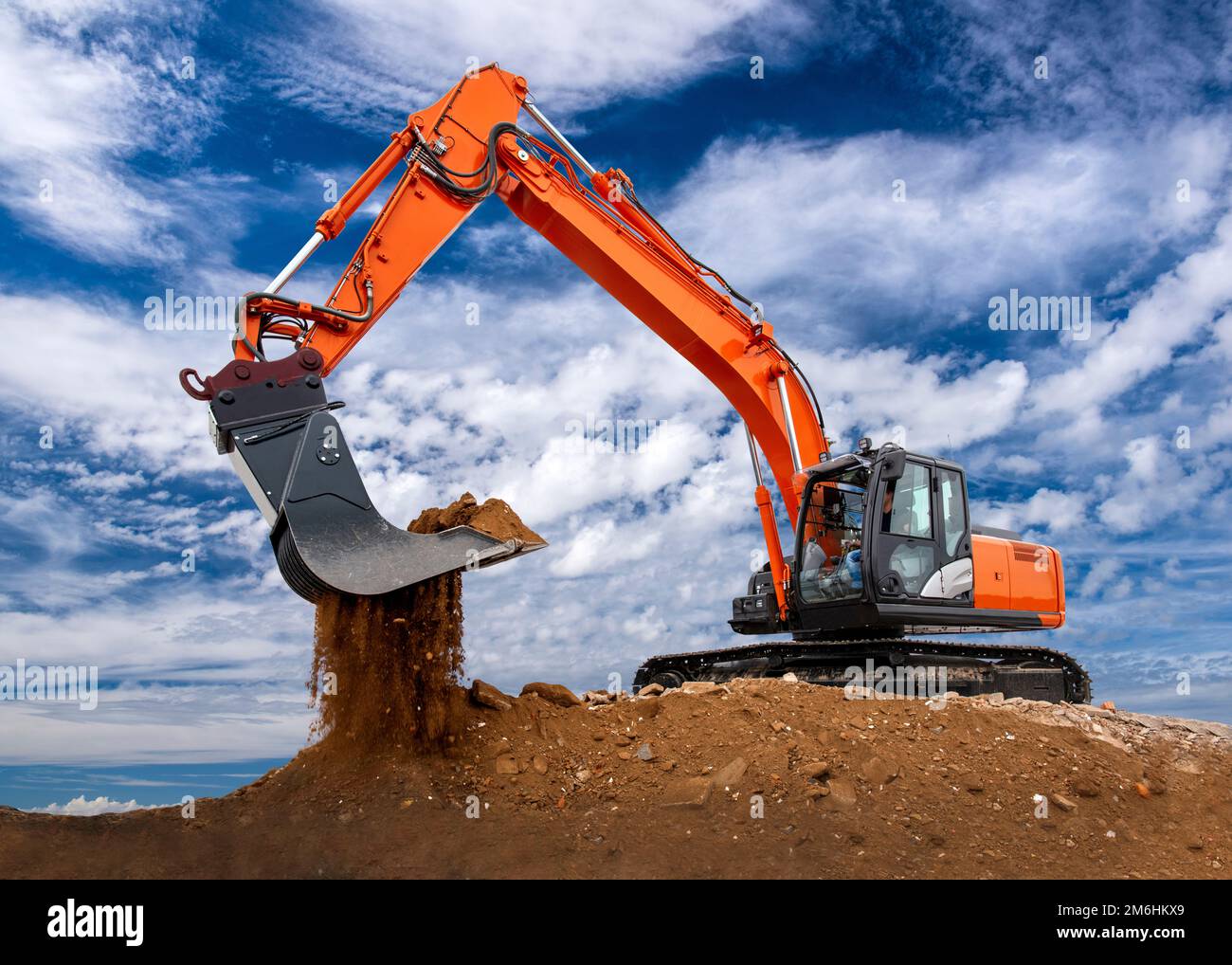 Excavator on construction site and truck at work Stock Photo - Alamy