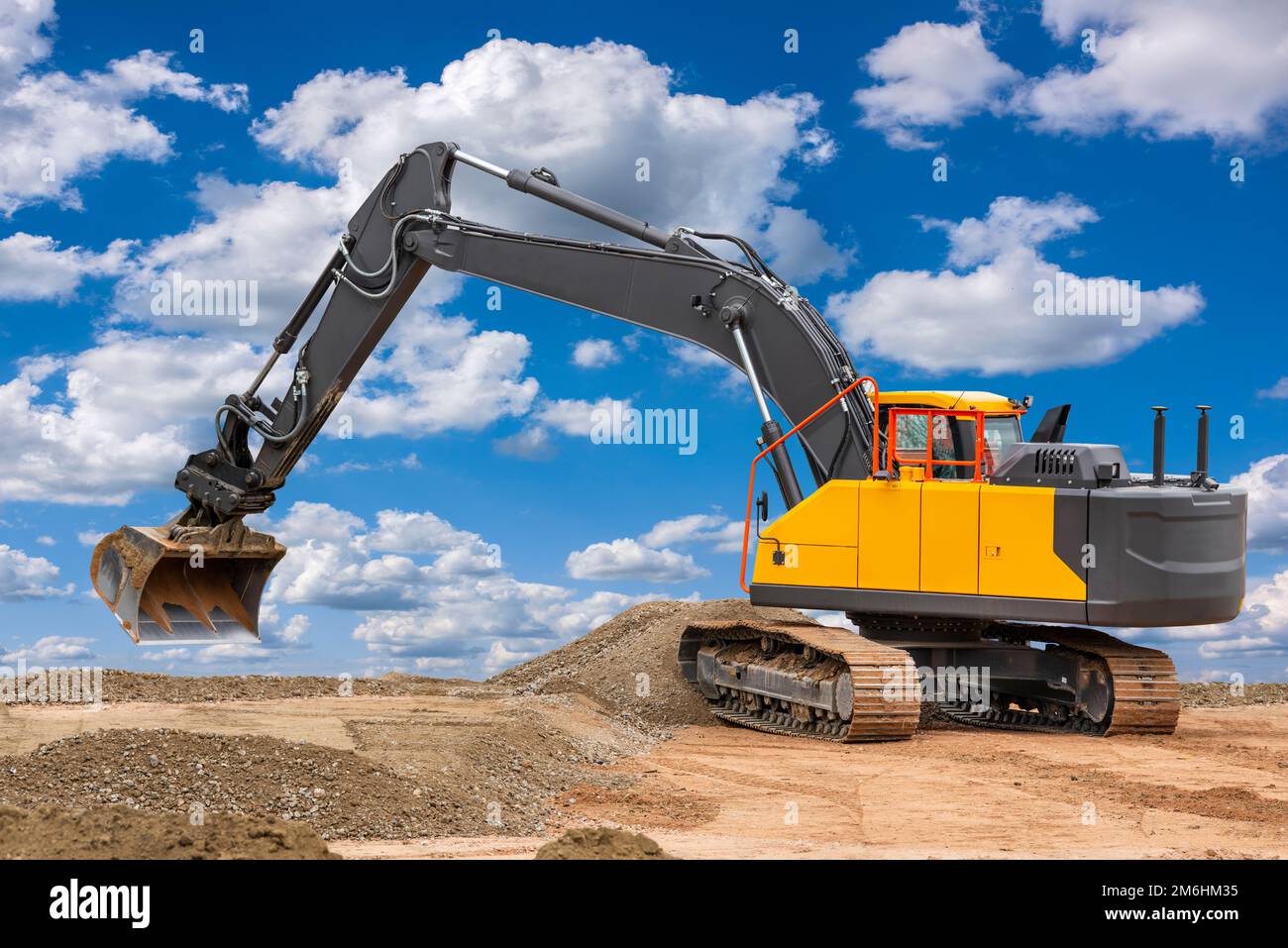 Excavator on construction site and truck at work Stock Photo - Alamy