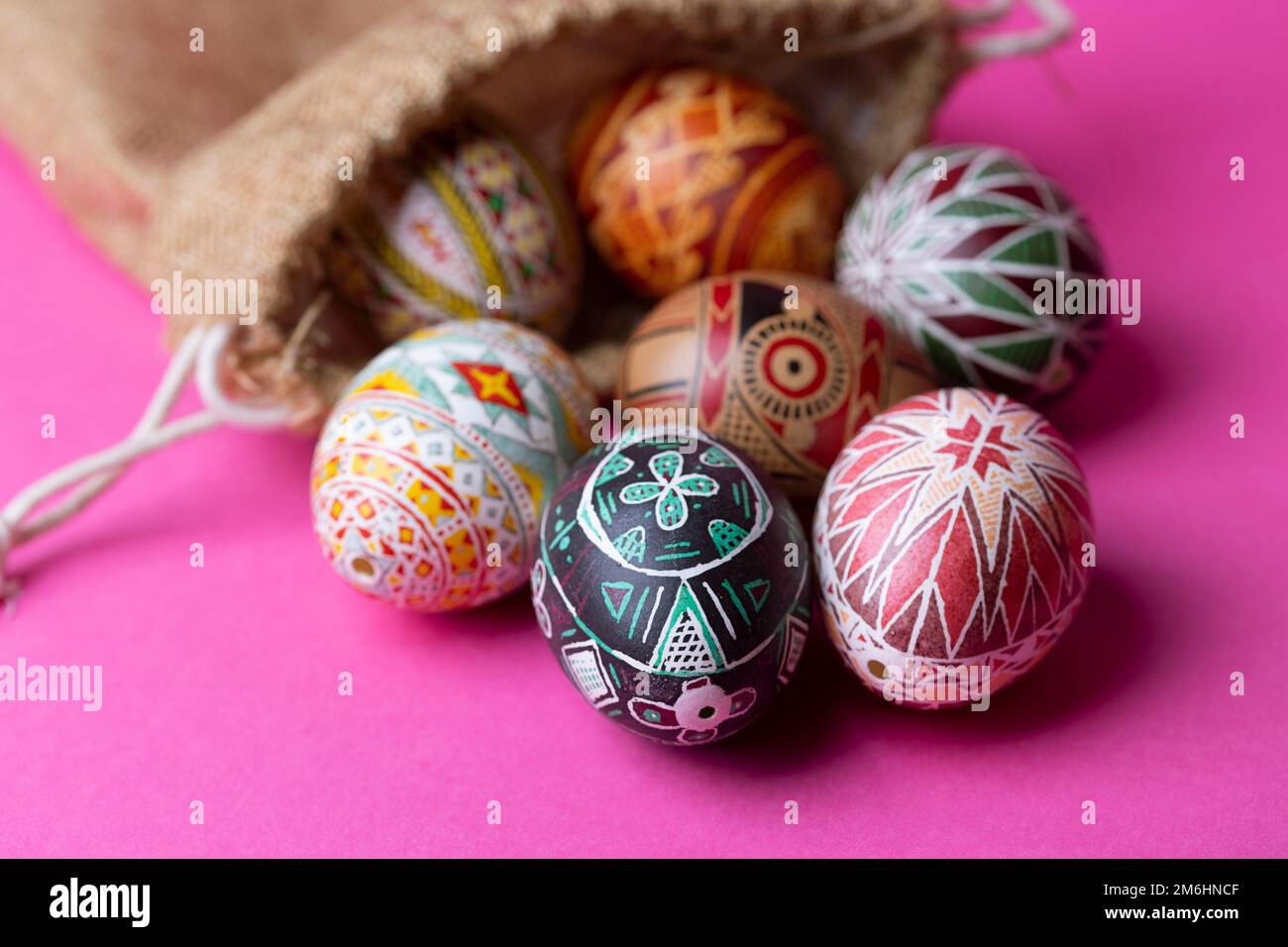 happy easter card. beautiful Easter egg Pysanka handmade on a pink ...