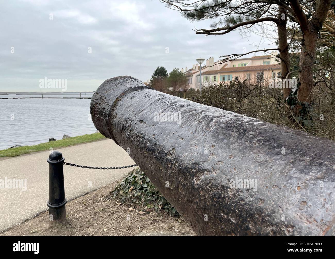 Old cannon pointed at a boat in the sea Stock Photo - Alamy
