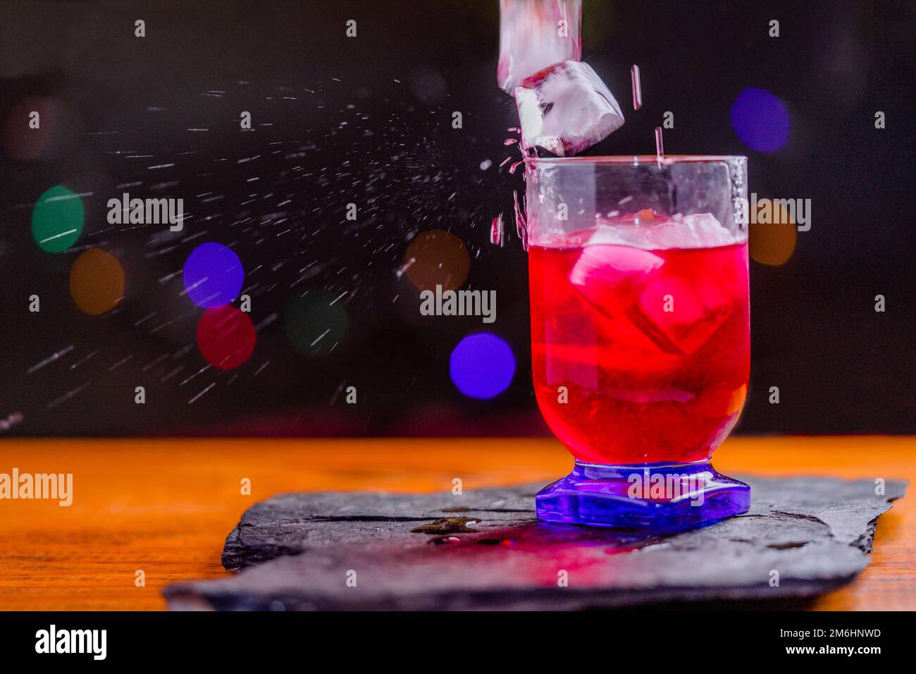 pink refreshing drink with ice at home with blue color stand and ...