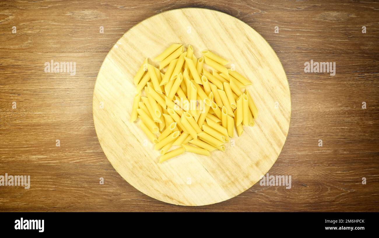 Penne Rigate Raw Pasta is a short pasta with oblique cuts and a ribbed ...