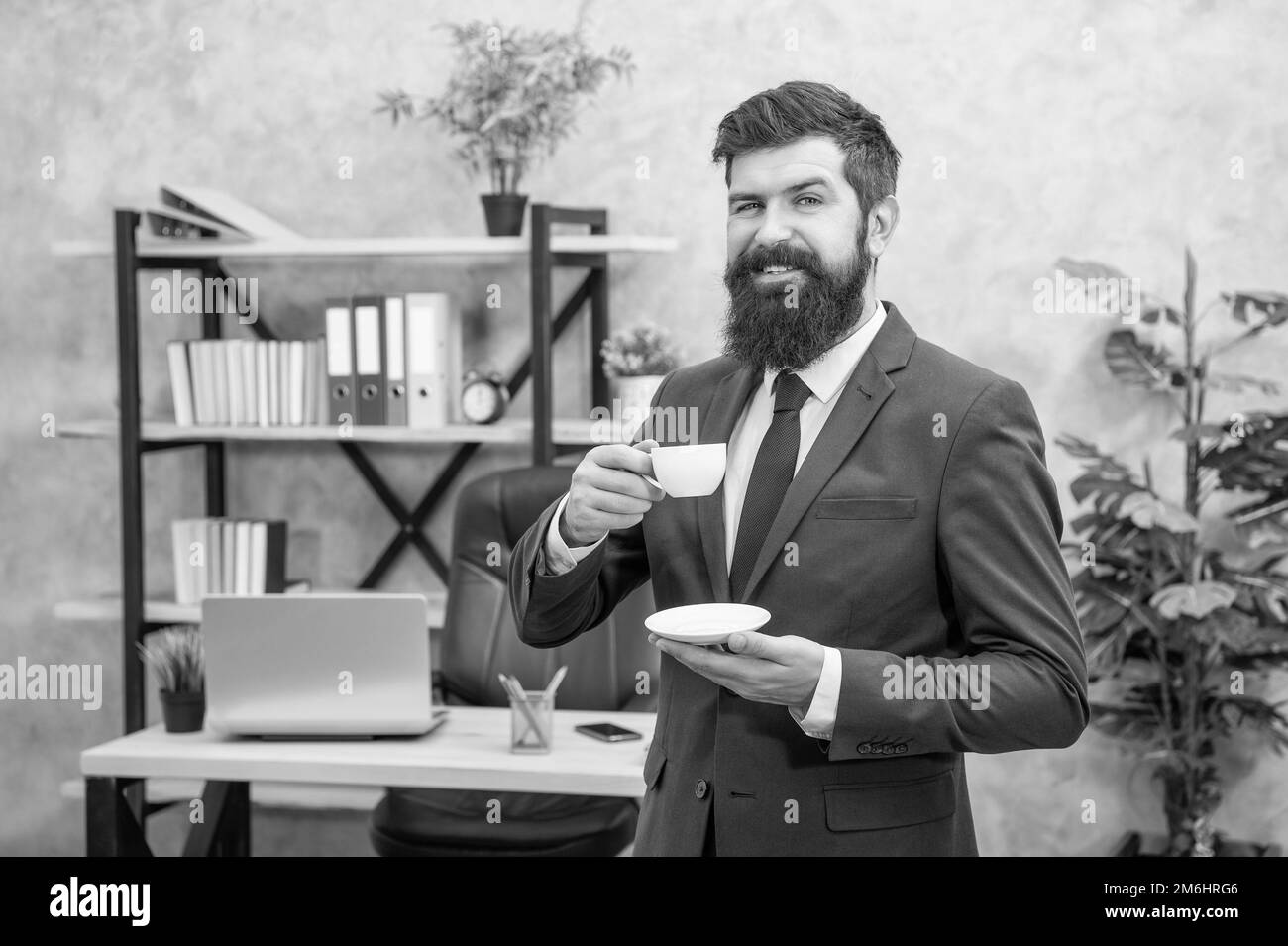 happy brutal ceo in businesslike suit has lunch break with coffee cup ...