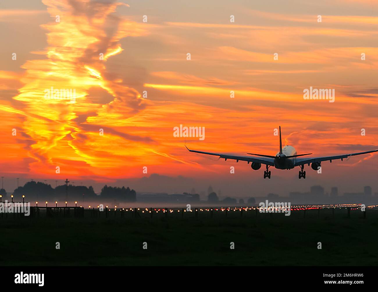 Takeoff of a passenger plane on the background of a sunset Stock Photo ...