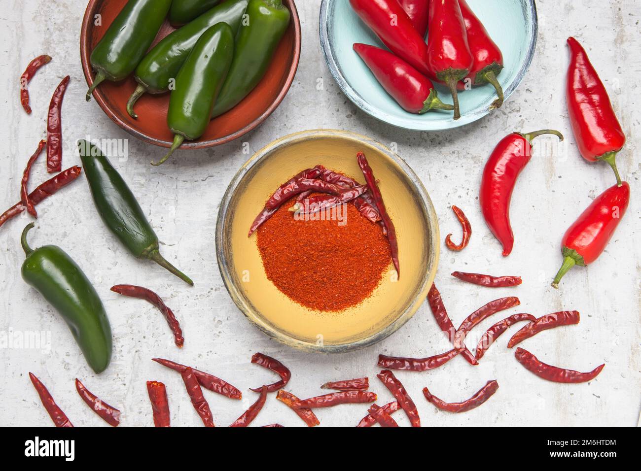 Various spicy peppers and powder Stock Photo - Alamy