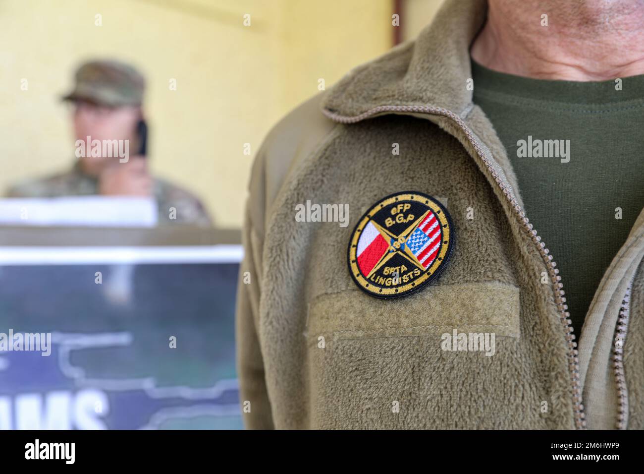 Patch on the chest of a Polish linguist as he stands by, ready to ...