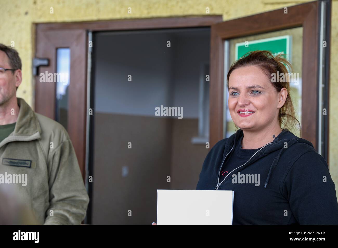 Marta Kaczkos, a linguist, smiles after receiving a certificate of ...