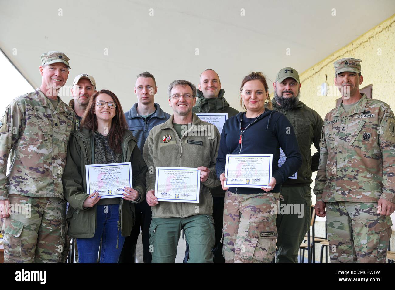 Linguists pose for a group photo with the command team of the 2nd ...