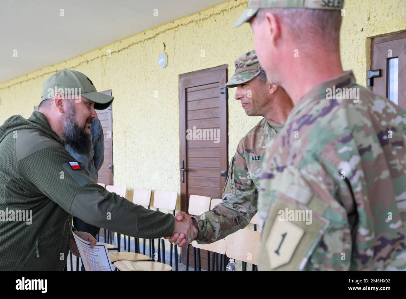 From left, Wojciech Szygula, a Polish linguist, shakes hands with U.S ...