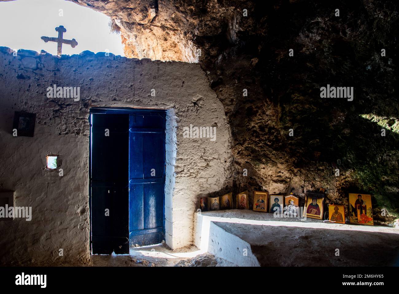 Interior of an old church cave with Christian saint pictures. Ayioi ...