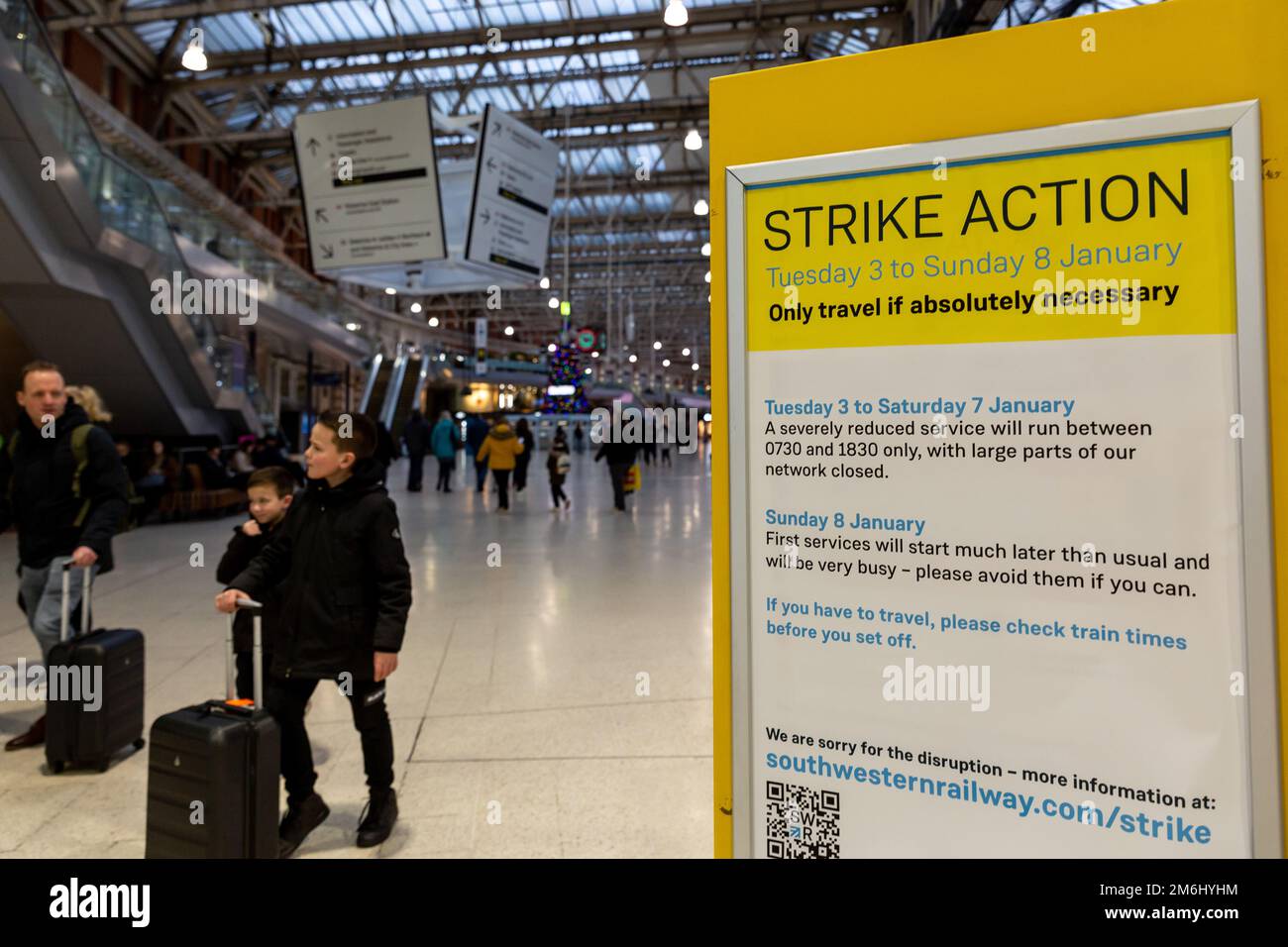 London, UK. 3rd Jan, 2023. Travelers walk past strike action ...