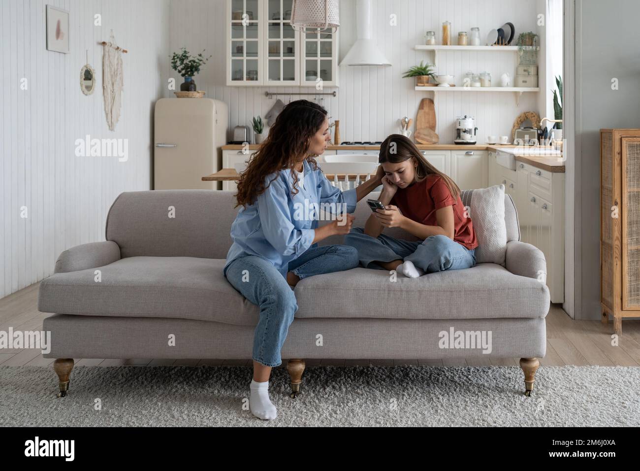 Loving supportive mother helping teen girl daughter through a ...