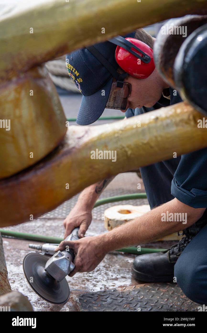 SAN DIEGO (28APR22) – A Sailor sands rust off the deck aboard Arleigh ...